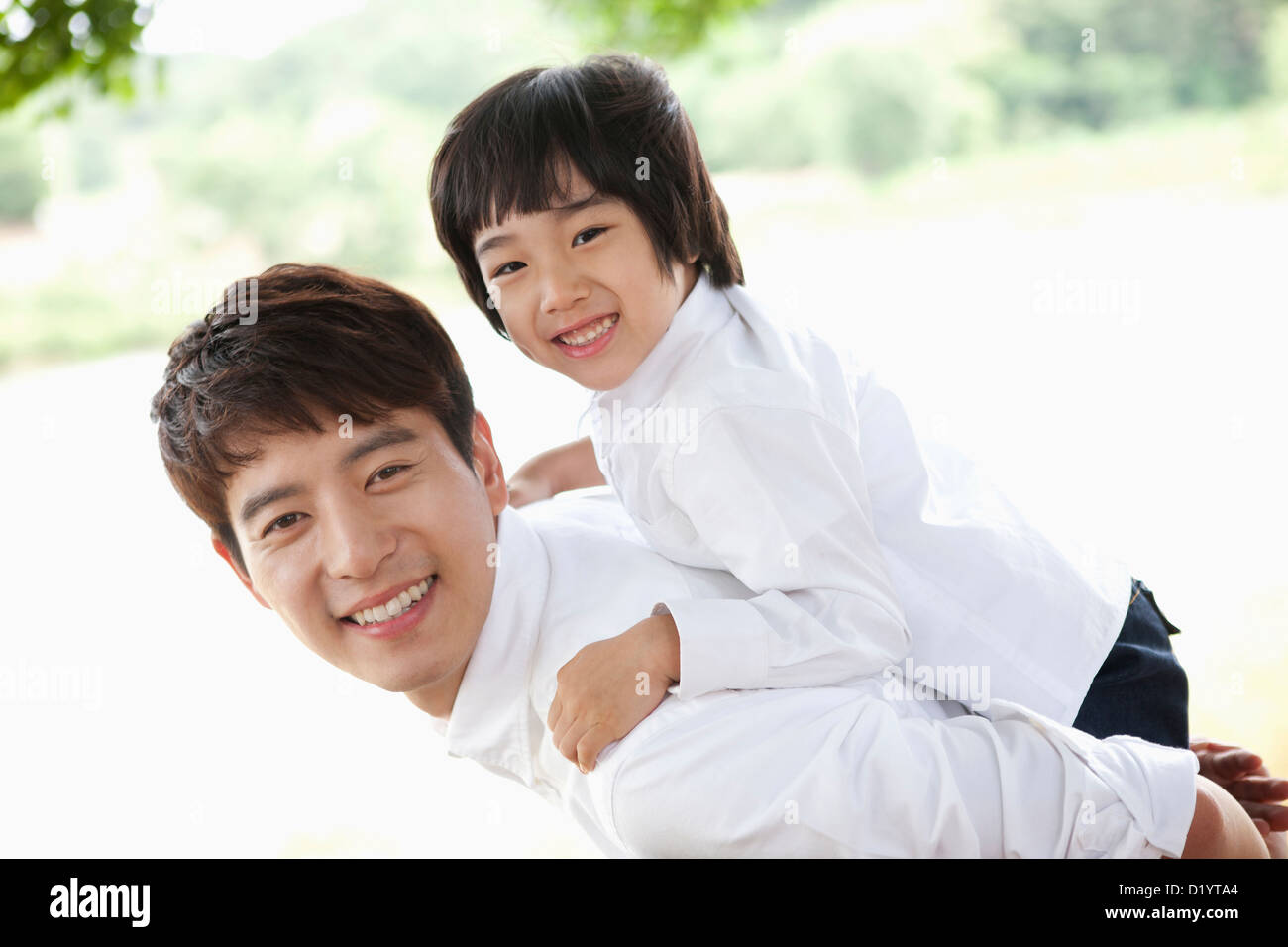 a son on father's back Stock Photo - Alamy