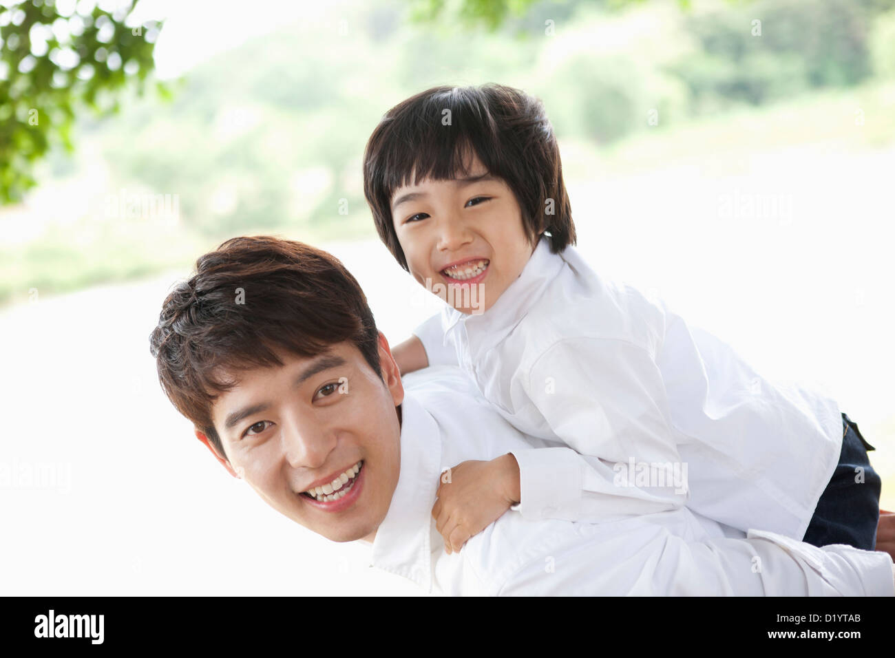 a son on father's back Stock Photo - Alamy