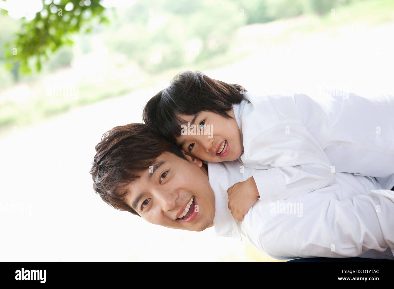 a son on father's back Stock Photo - Alamy