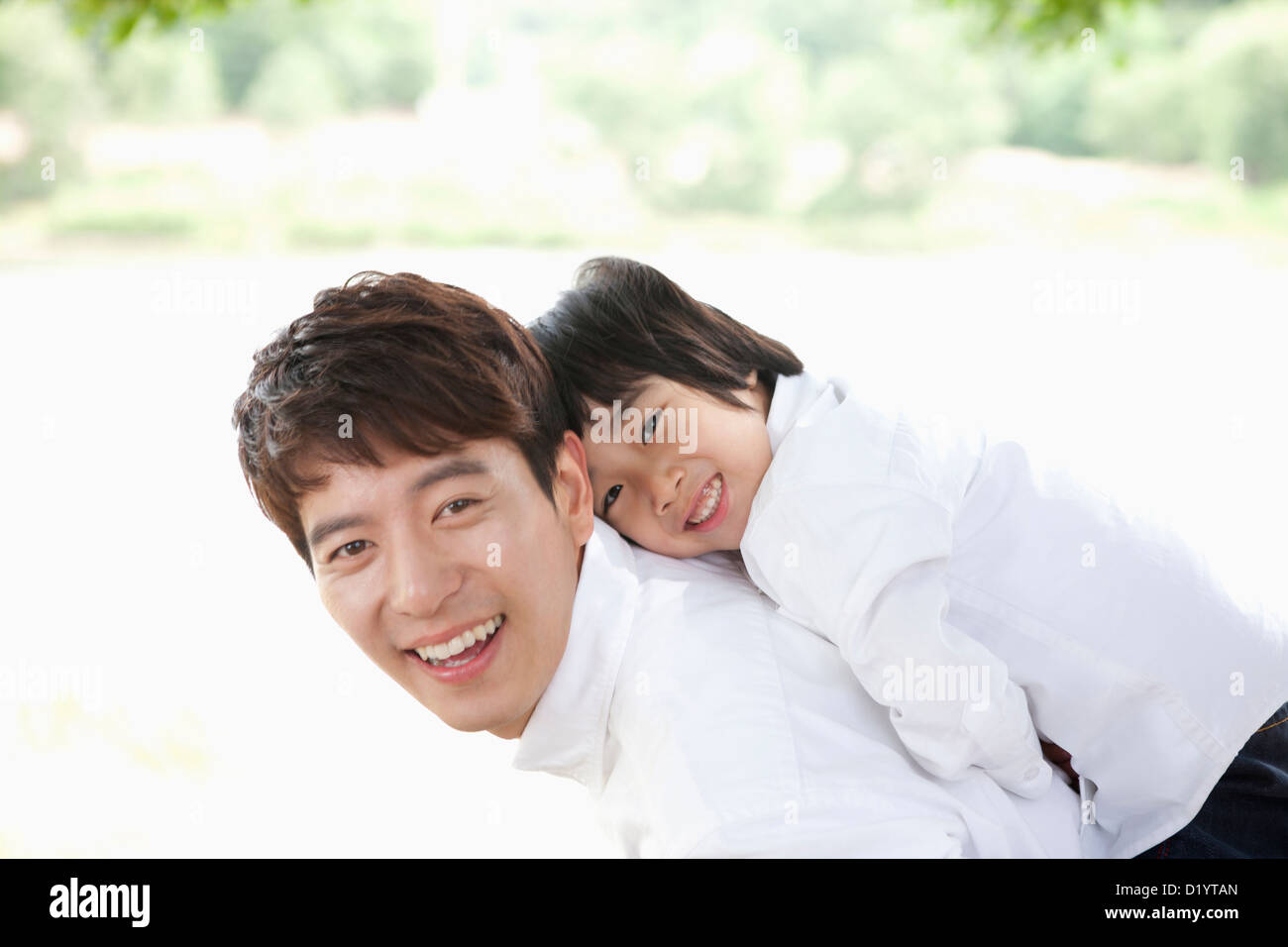 a son on father's back Stock Photo - Alamy