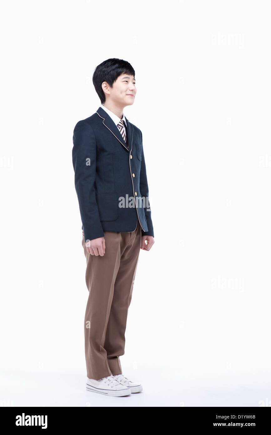 a male student with school uniform standing up straight Stock Photo - Alamy