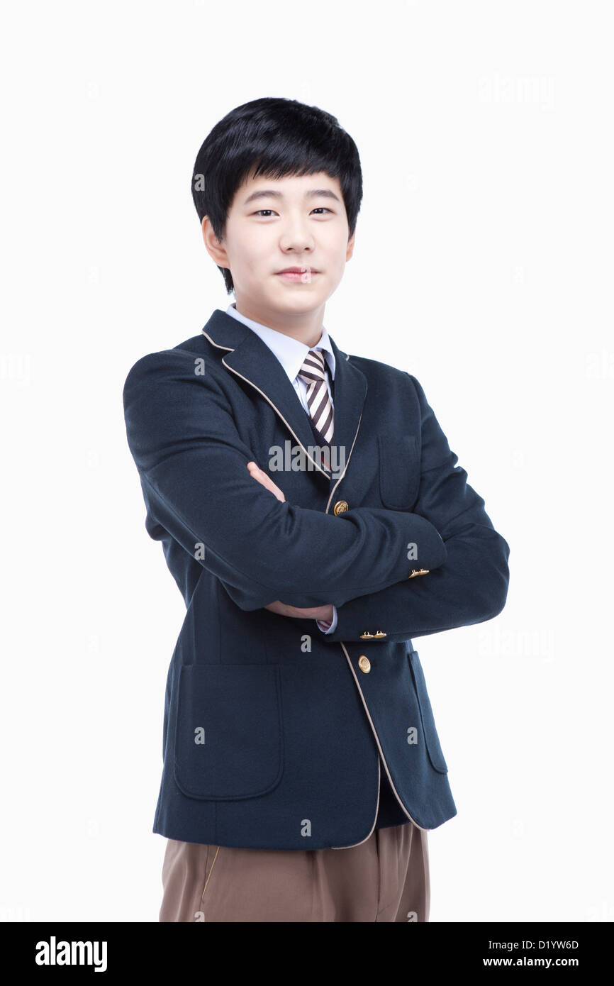 a male student wearing school uniform standing with arms crossed Stock ...