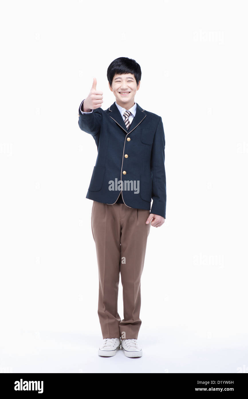 a male student wearing school uniform standing with thumbs up Stock ...