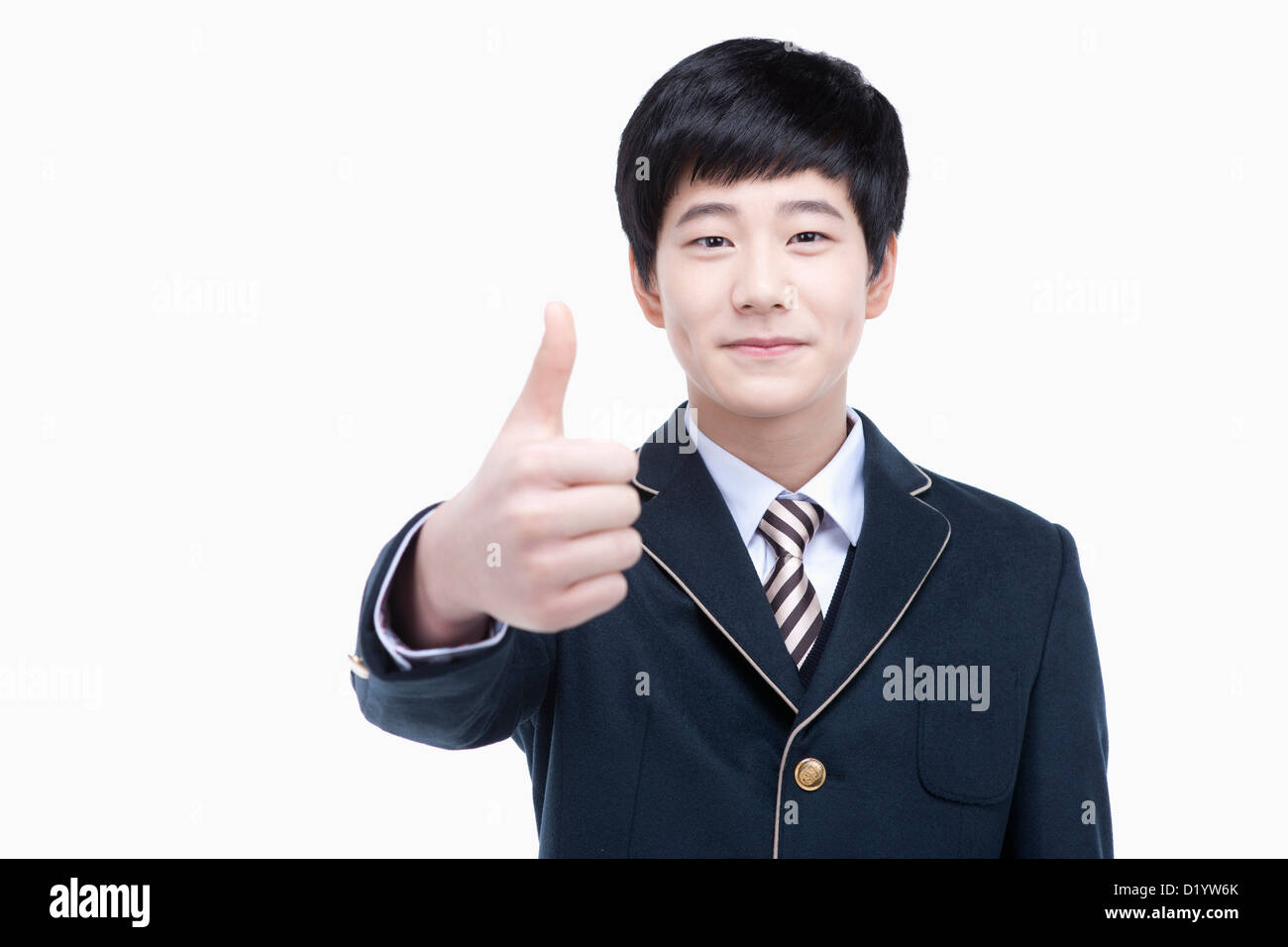 a male student wearing school uniform standing with thumbs up Stock ...