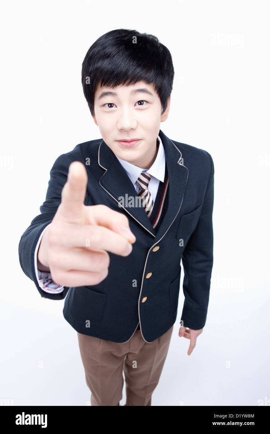 a male student wearing school uniform pointing at camera Stock Photo ...