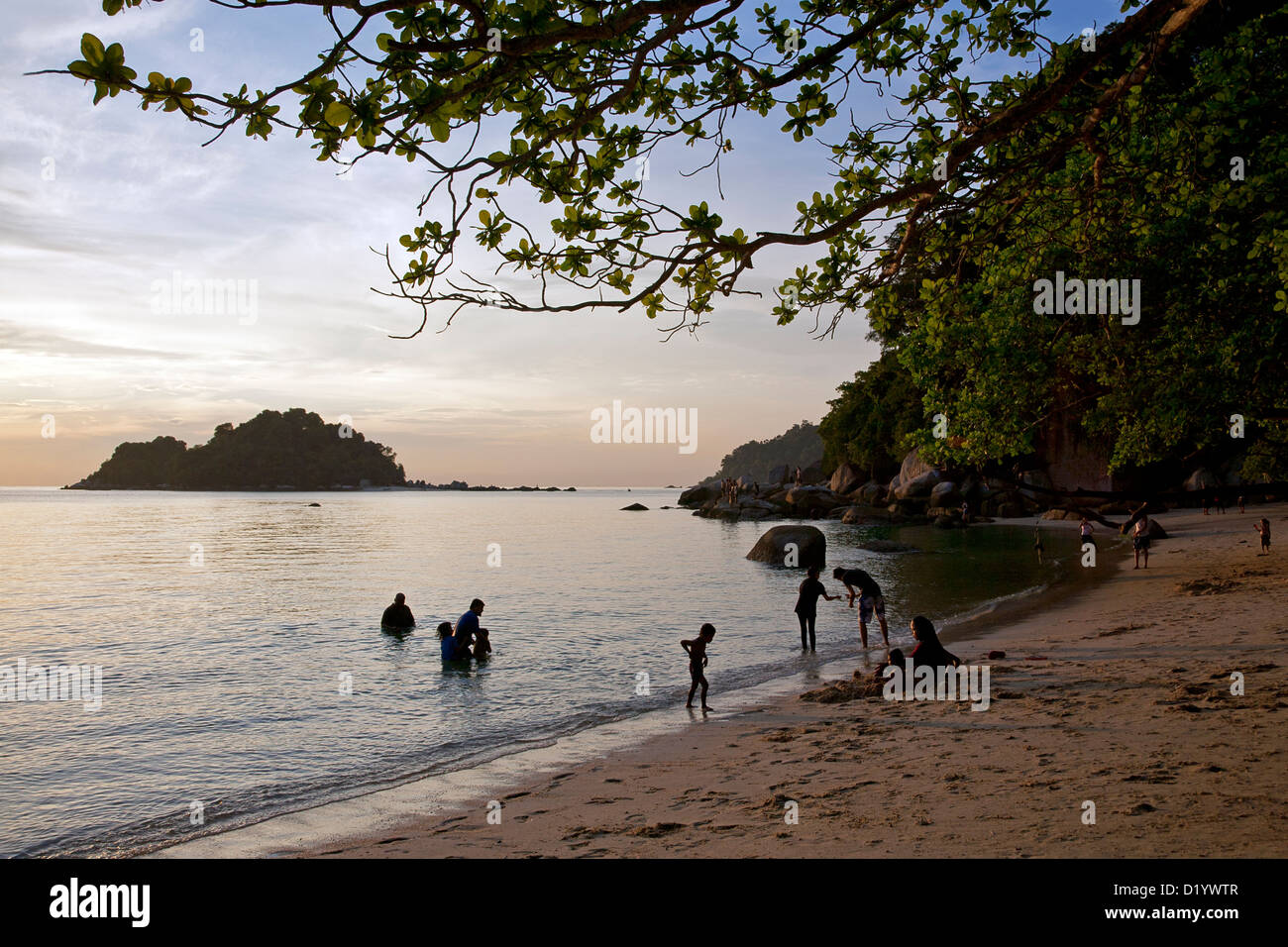 People swimming at sunset. Teluk Nipah beach. Pulau Pangkor Island ...