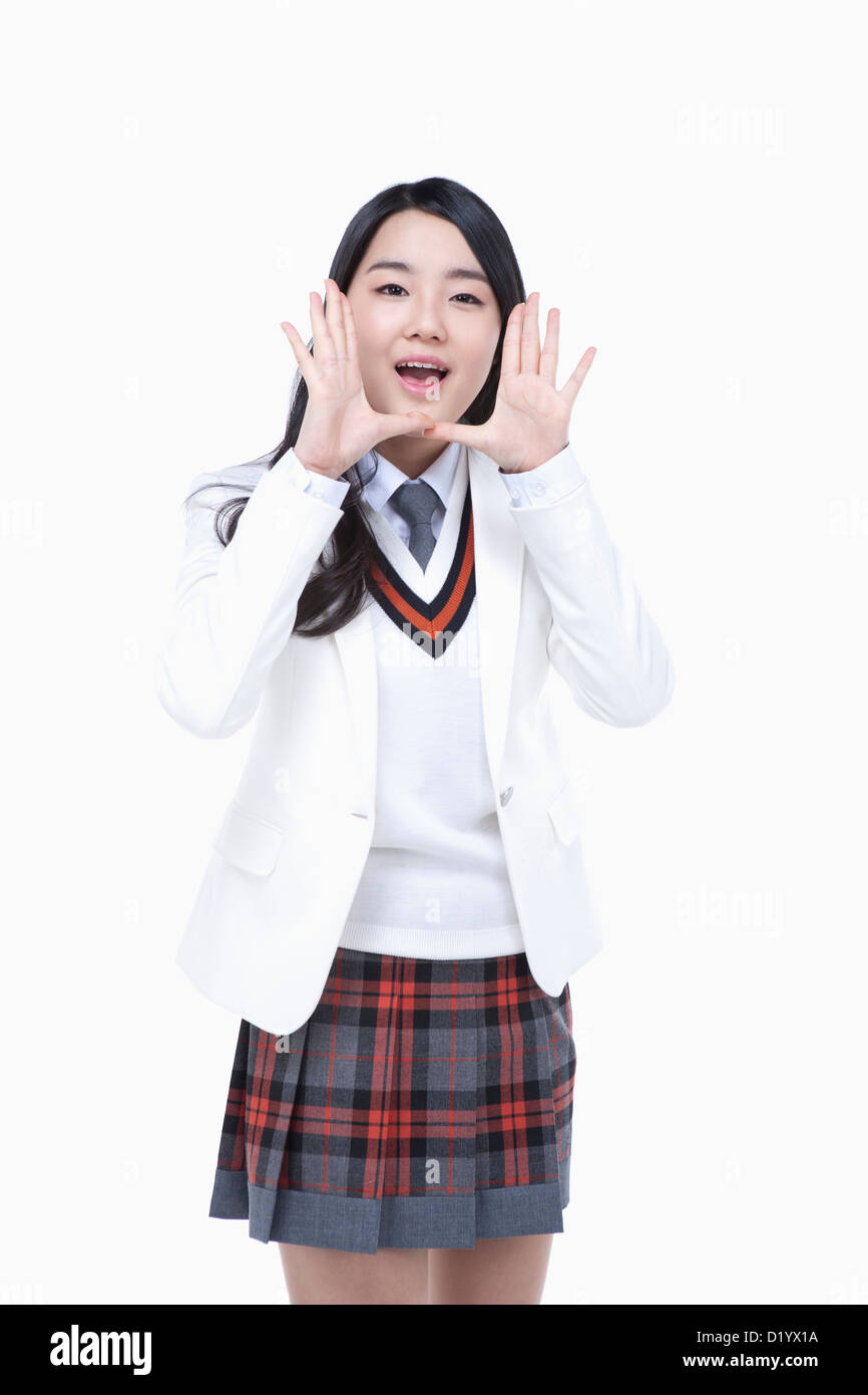a female student in school uniform wearing a white jacket with shouting ...