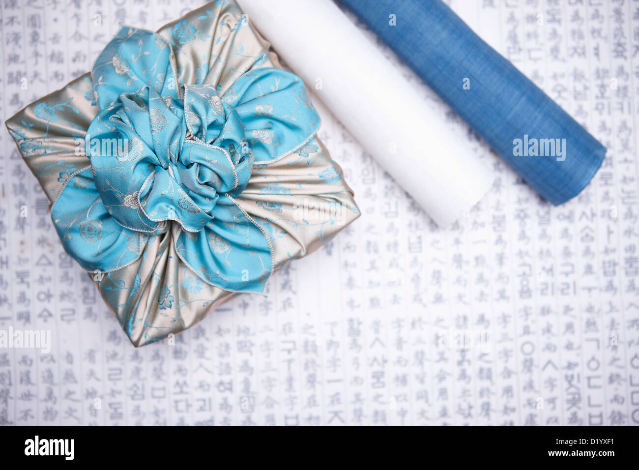 traditional papers next to a package wrapped in a traditional wrap with ...