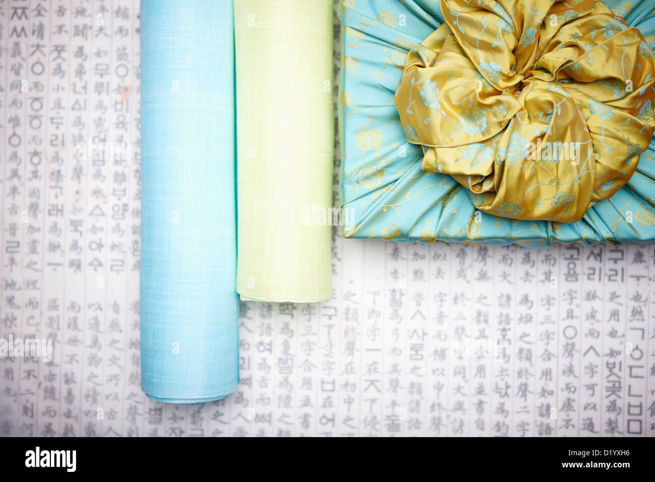 traditional papers next to a package wrapped in a traditional wrap with ...