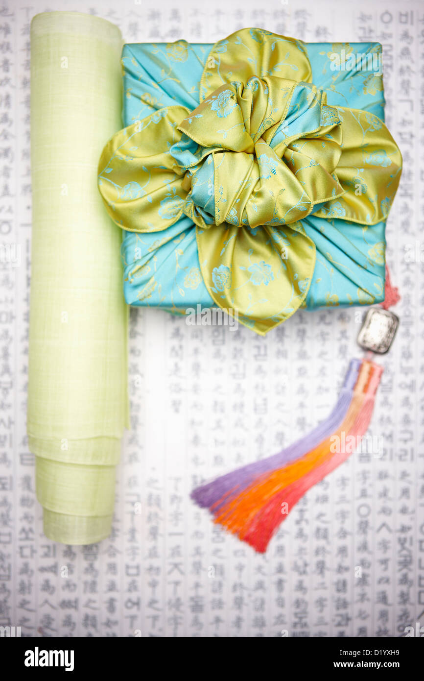 traditional paper next to a package wrapped in a traditional wrap with ...