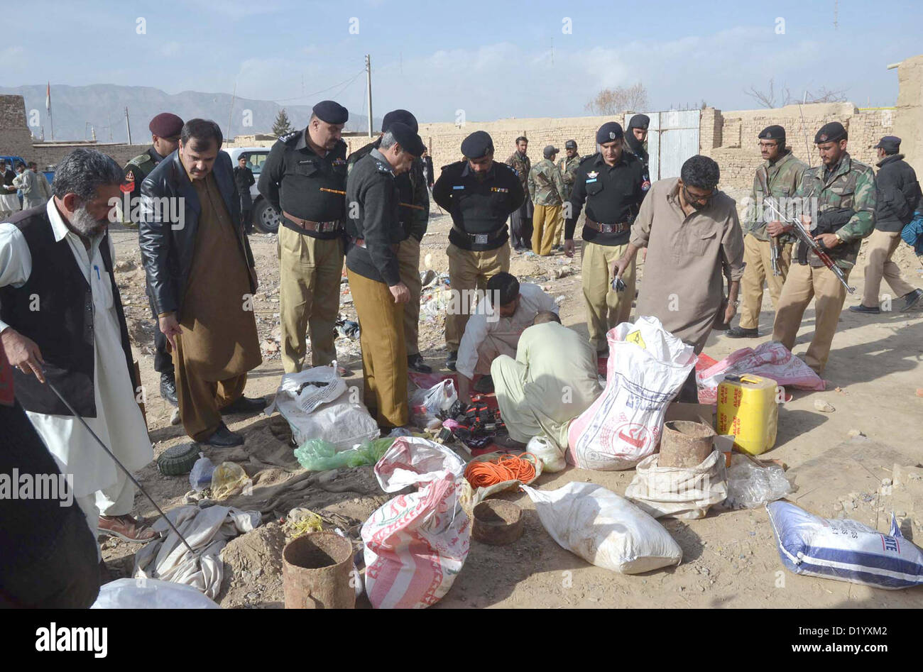 Police officials categorizing seized weapons that recovered during a ...