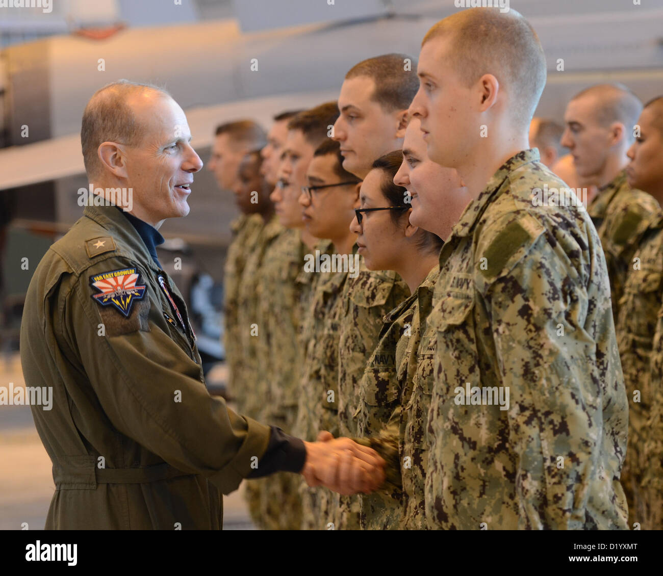 Rear Adm. John Haley, Commander of Carrier Strike Group 5, presents a ...