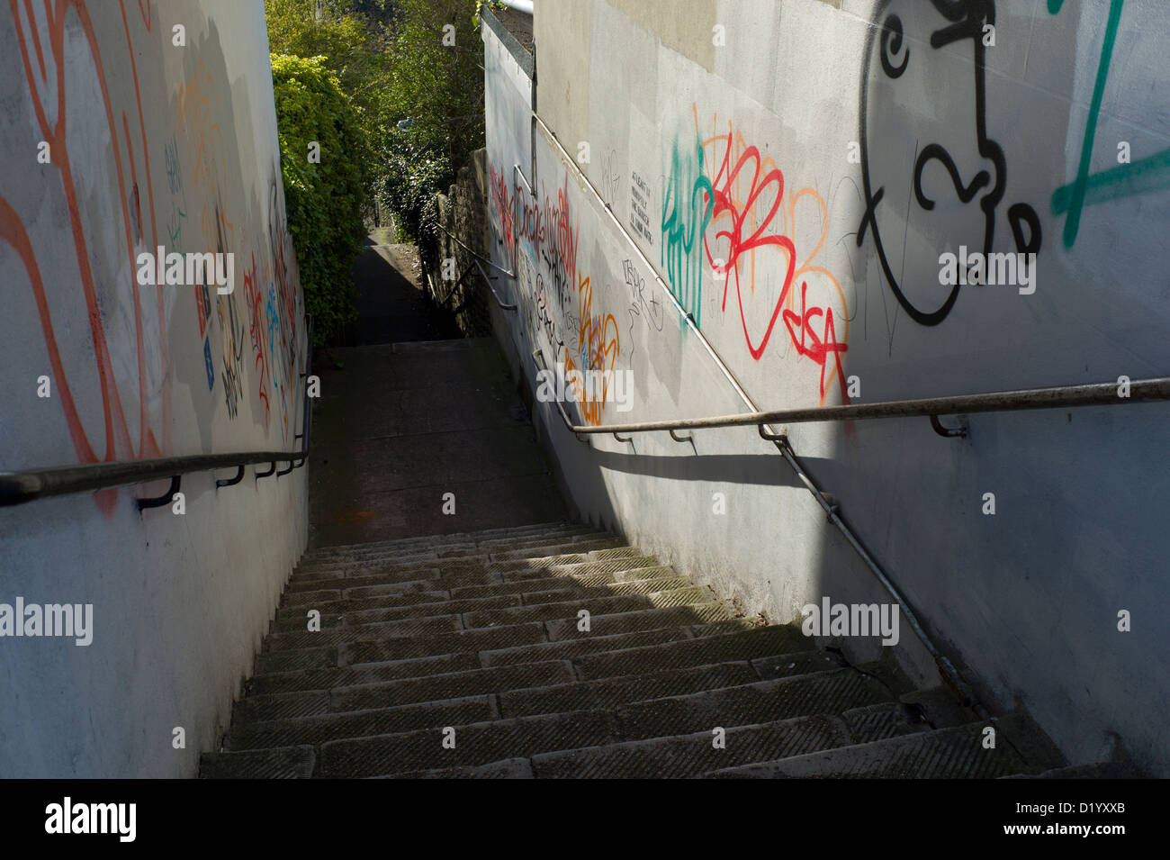 Urban steps leading down , graffiti, shadows Stock Photo - Alamy