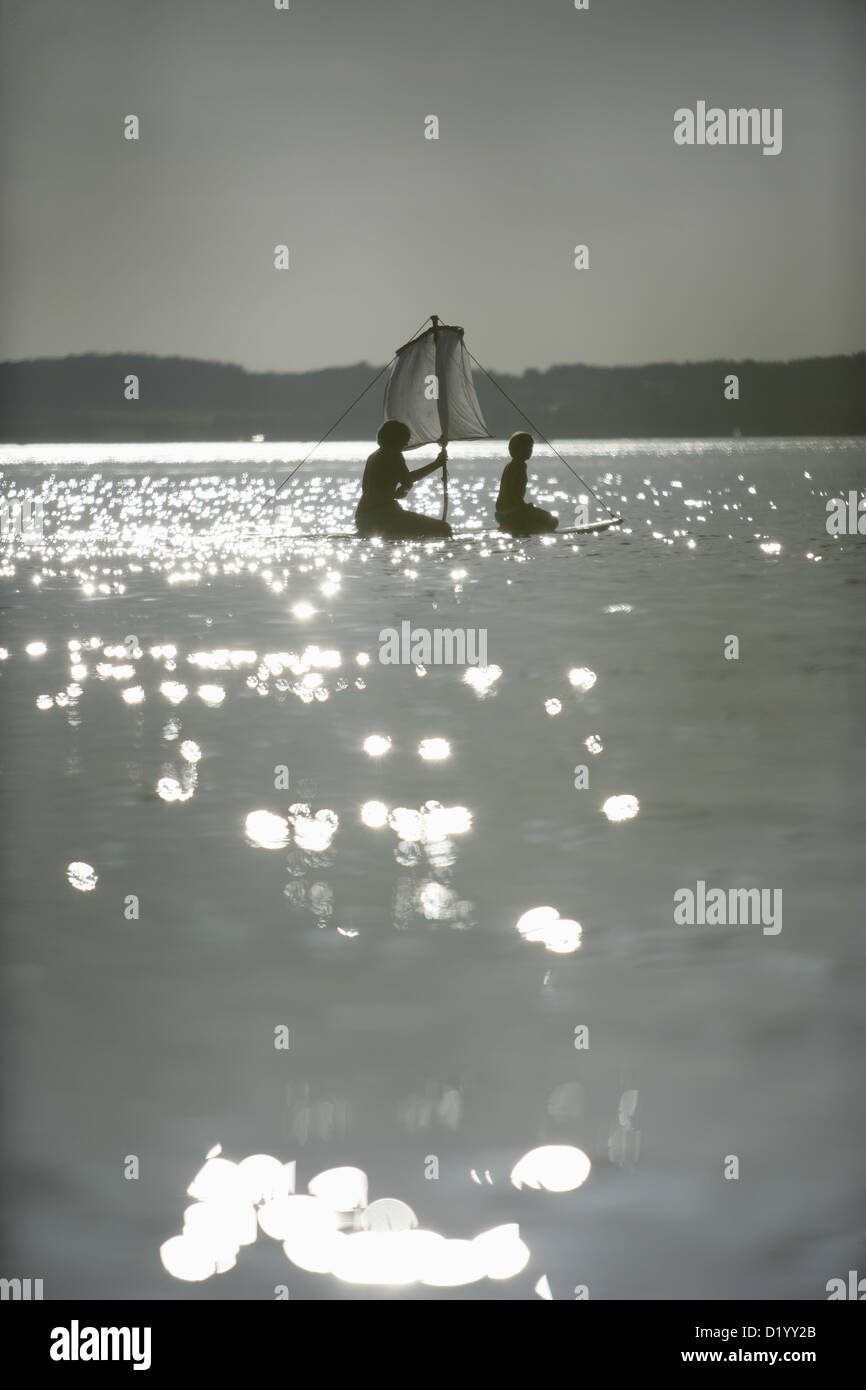 Two kids on a small raft with sail, Ammerland, Lake Starnberg, Bavaria ...