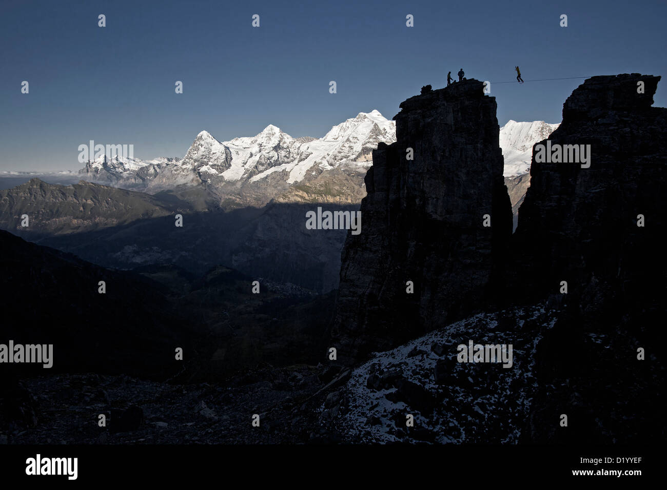 Man walking a highline between two rocks, Schilthorn, Bernese Oberland ...