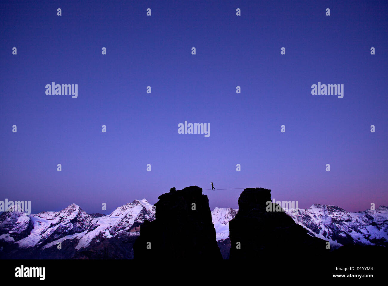 Man walking a highline between two rocks, Schilthorn, Bernese Oberland ...