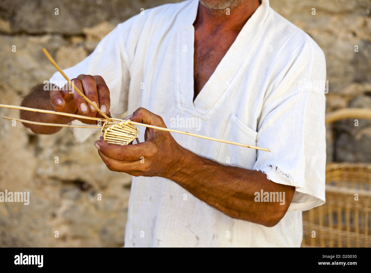 A man weaving baskets at the medieval market in Gruissan, Southern ...