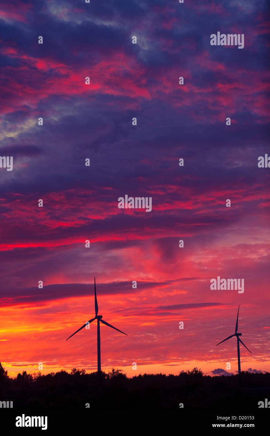 A silhouette of windturbines on a amazing sunset Stock Photo - Alamy