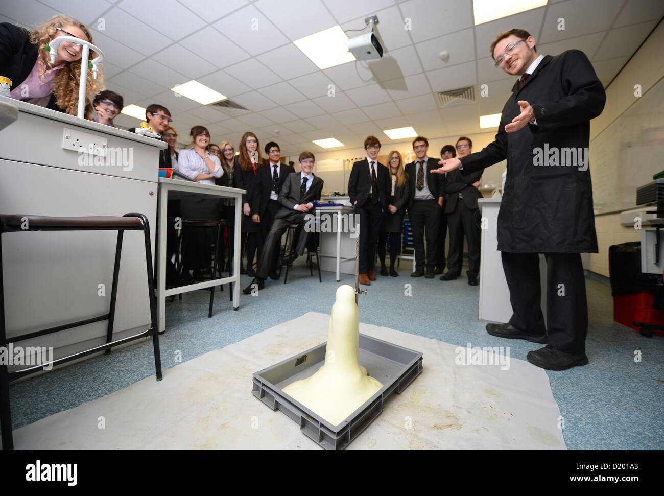 A teacher demonstrates a chemistry experiment during a science lesson ...