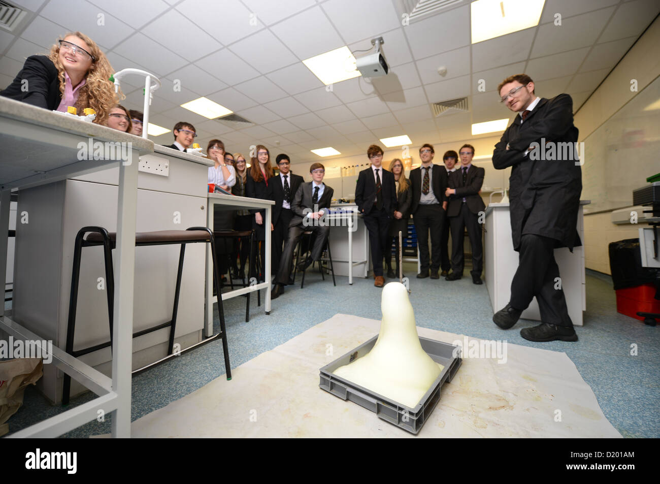 A teacher demonstrates a chemistry experiment during a science lesson ...