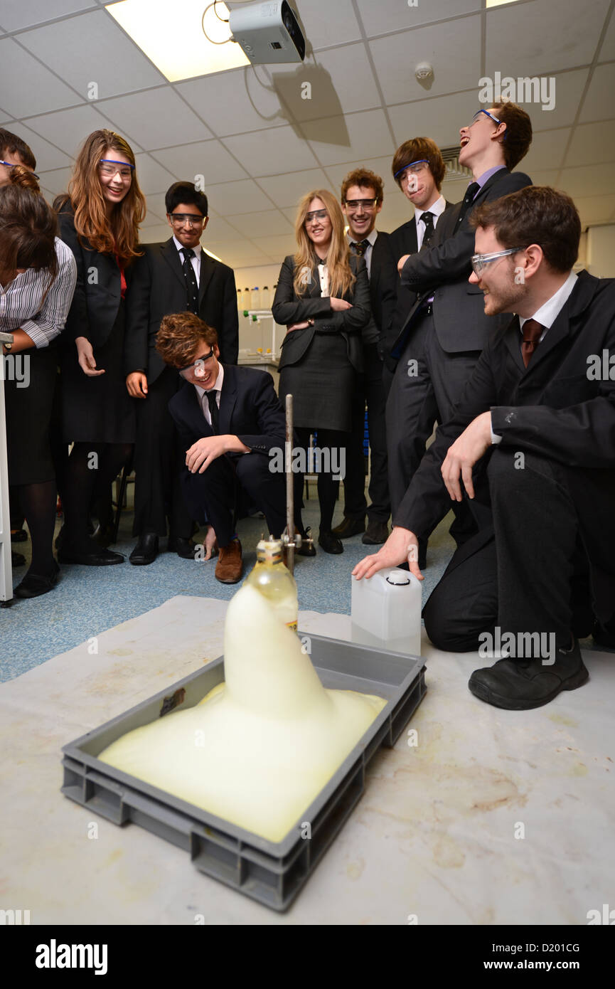 A teacher demonstrates a chemistry experiment during a science lesson ...