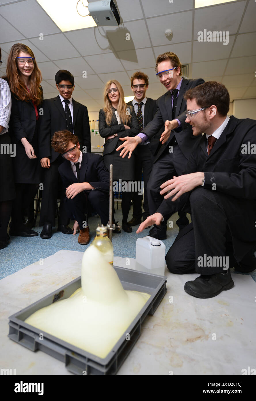 A teacher demonstrates a chemistry experiment during a science lesson ...
