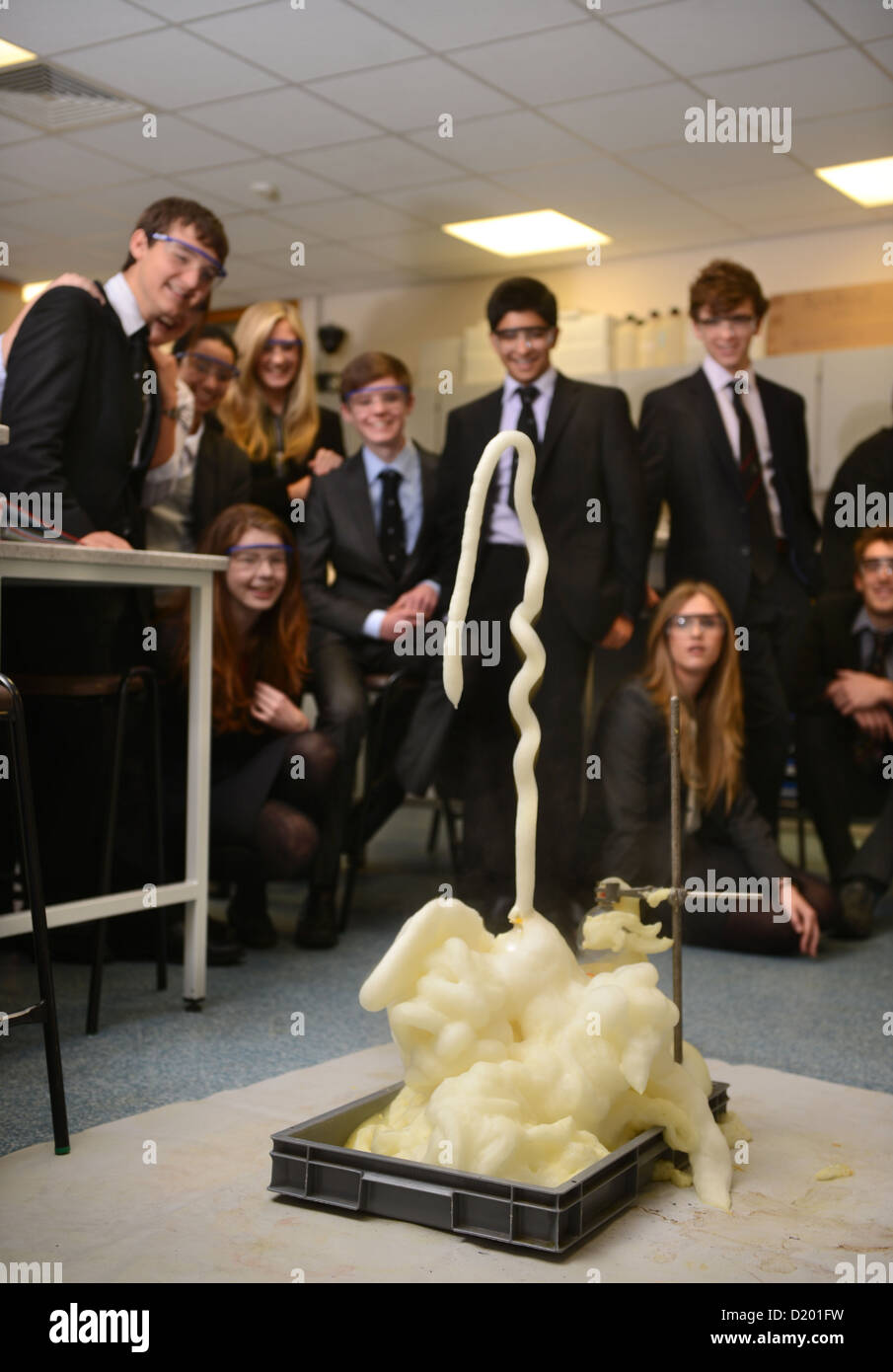 A teacher demonstrates a chemistry experiment during a science lesson ...