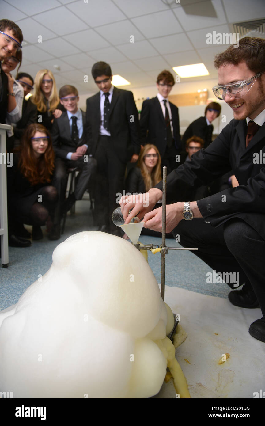 A teacher demonstrates a chemistry experiment during a science lesson ...