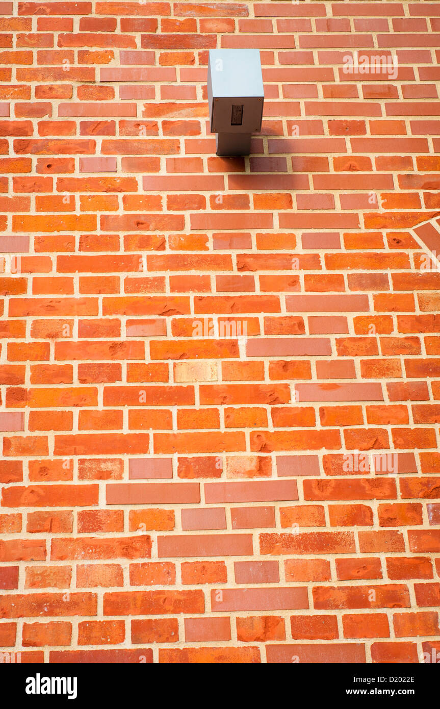An image of security camera instaleed on red brick wall Stock Photo - Alamy
