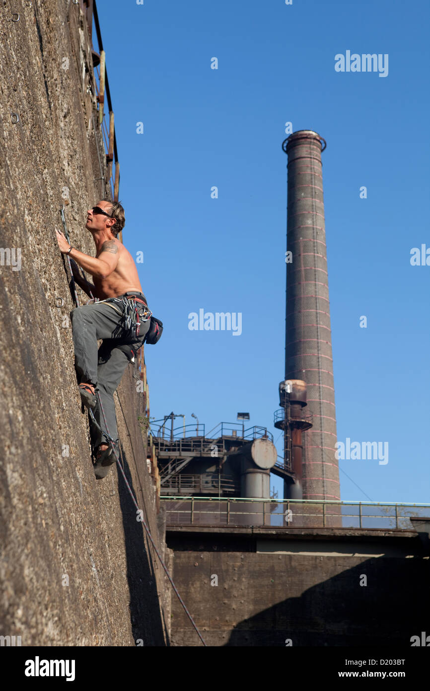 Duisburg, Germany, a young man climbing the Landscape Park Duisburg ...