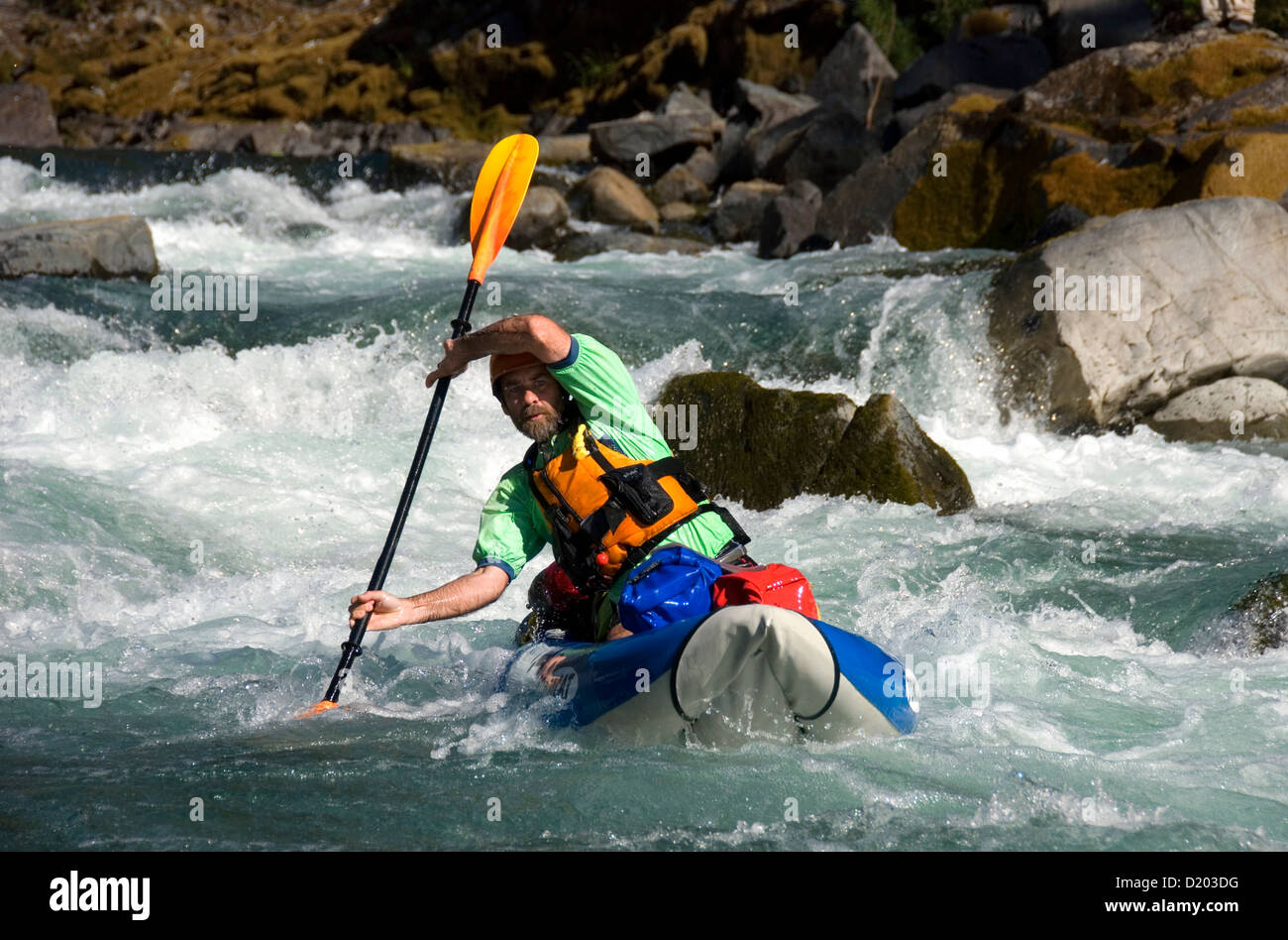 Paddling an inflatable kayak down a rapid on the Illinois River in ...