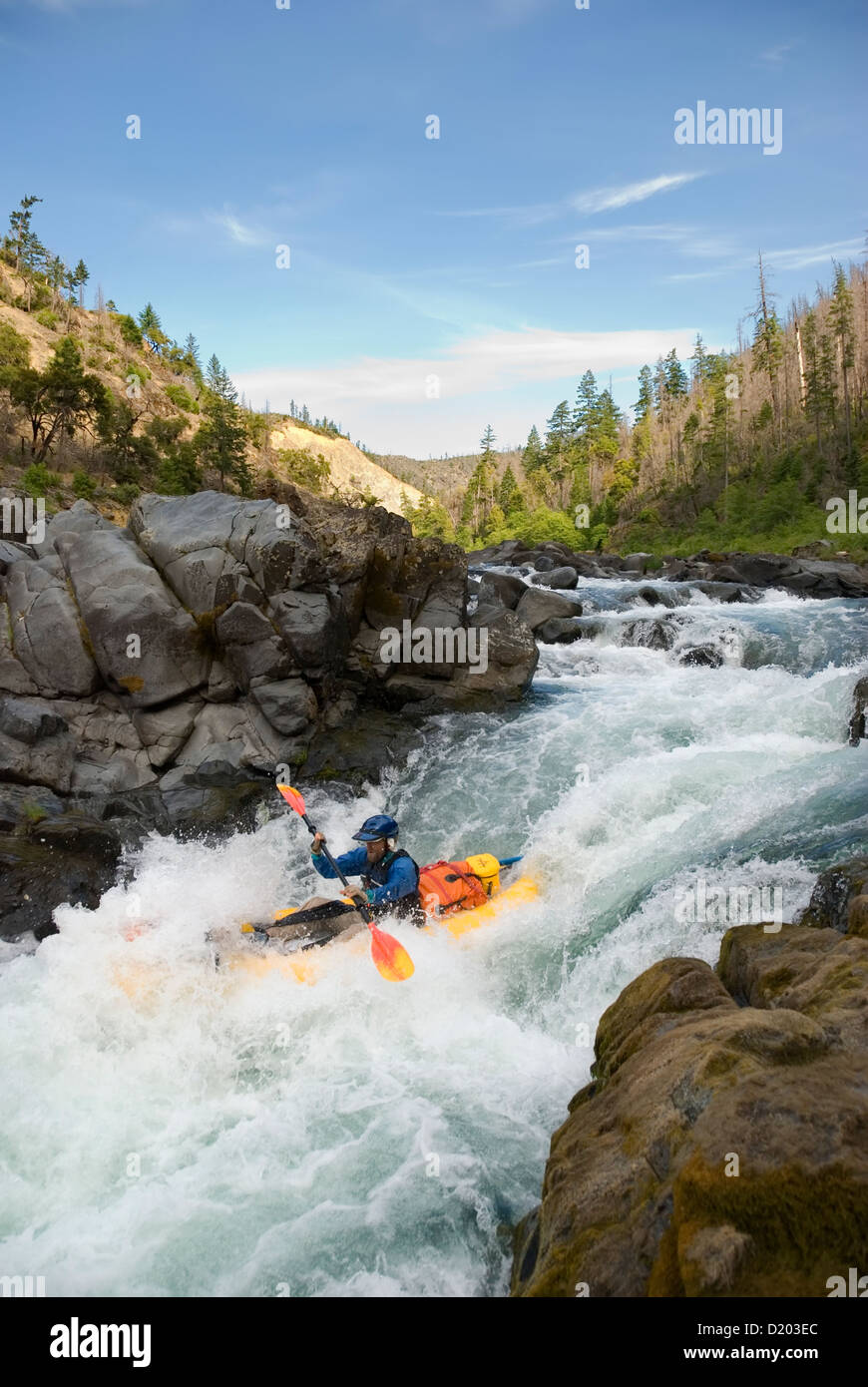 Paddling an inflatable kayak through a rapid on the Illinois River in ...