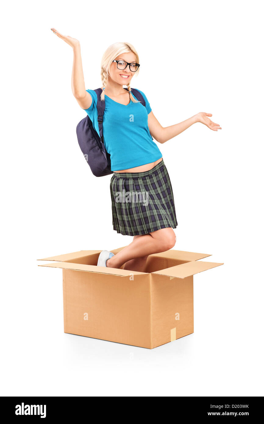 An excited female student with raised hands posing in a paper box ...