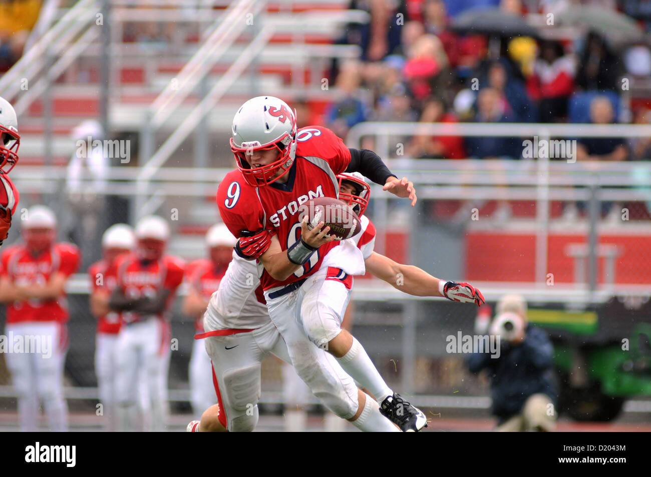 Football Quarterback tackled for a sack during a high school game.USA ...