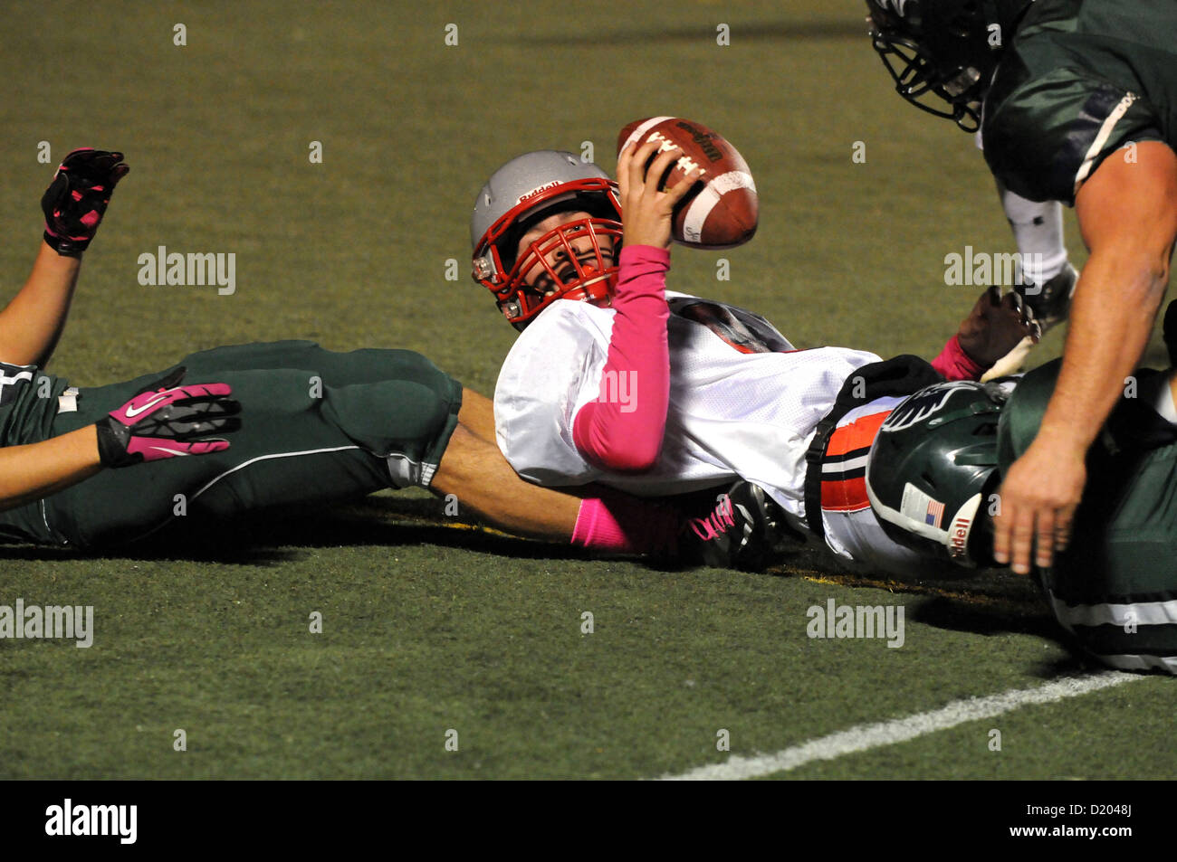 Football quarterback looks to an official to confirm his touchdown run ...