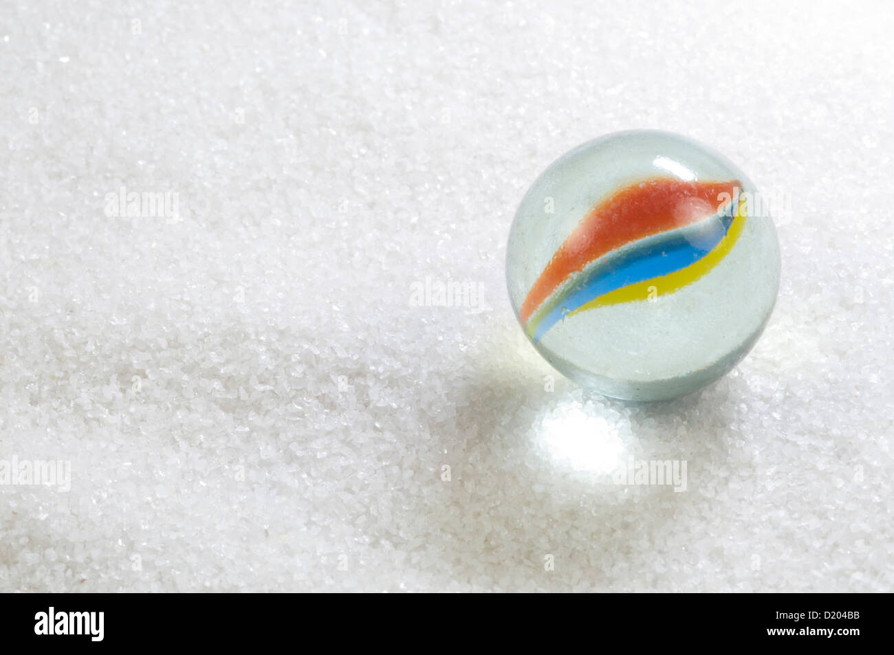 Glass Marbles on Sand Stock Photo - Alamy