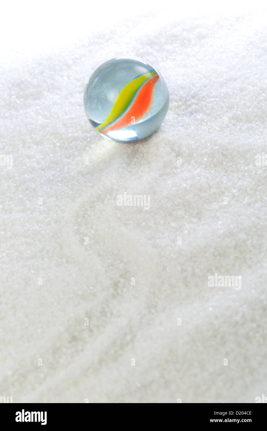 Glass Marbles on Sand Stock Photo - Alamy