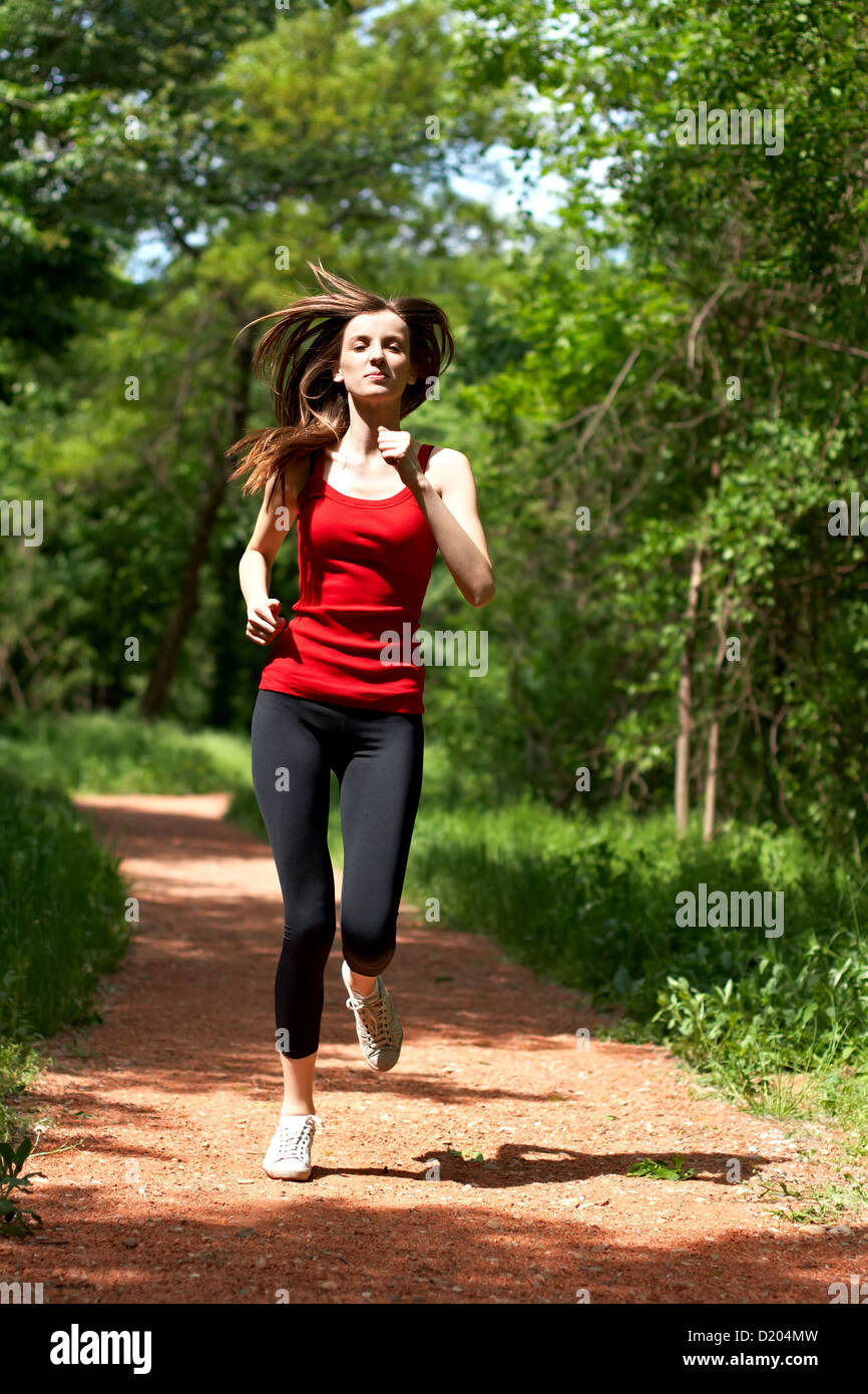 Fitness woman running in natural environment Stock Photo - Alamy