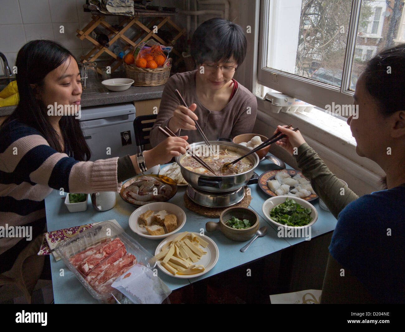 Chinese women eating hot pot at home in Shanghai Stock Photo - Alamy