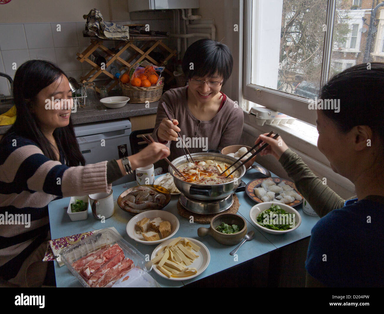 Chinese women eating hot pot at home in Shanghai Stock Photo - Alamy