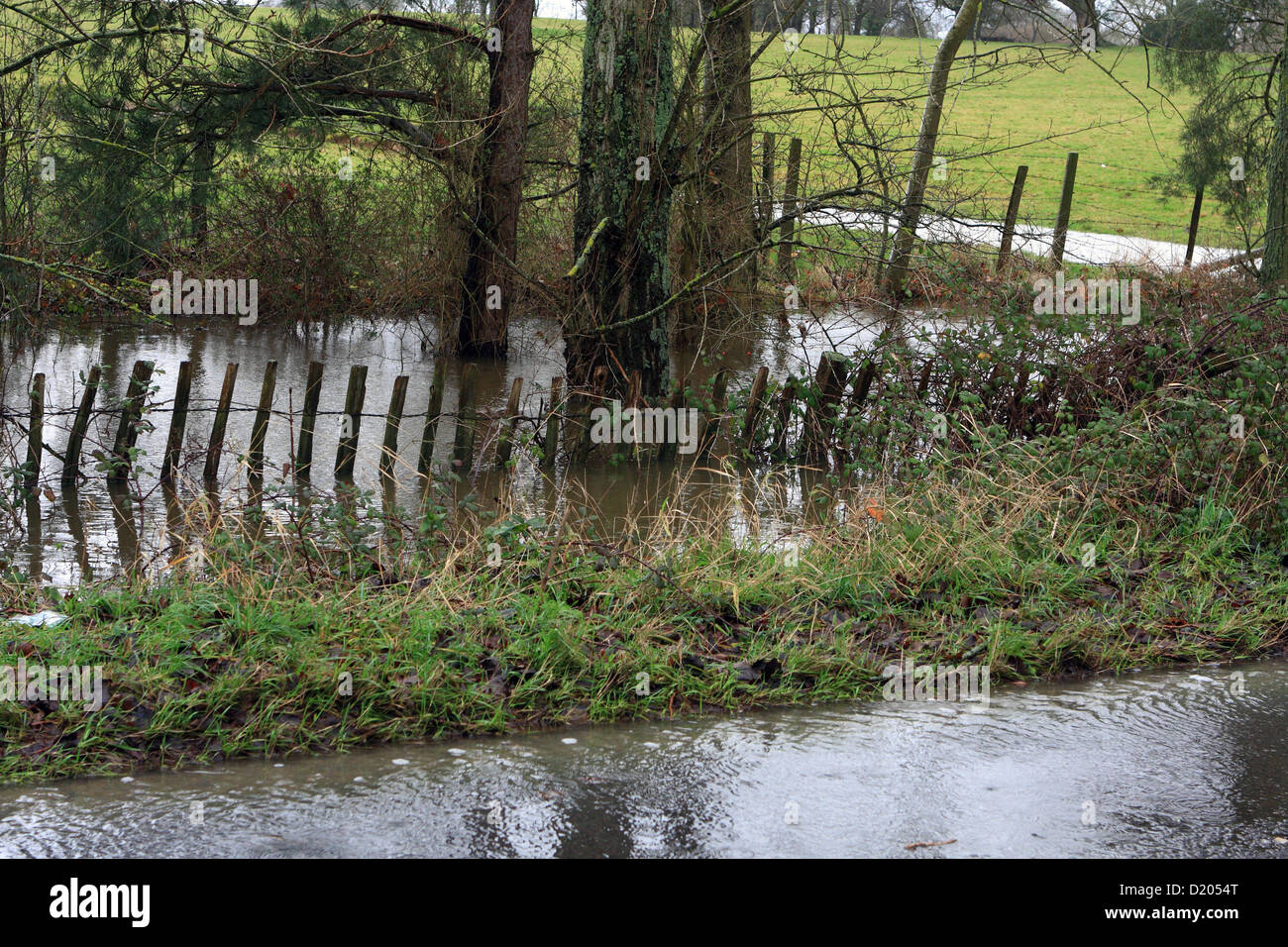 Flood water running down the side of a slope and flooding the verge and ...