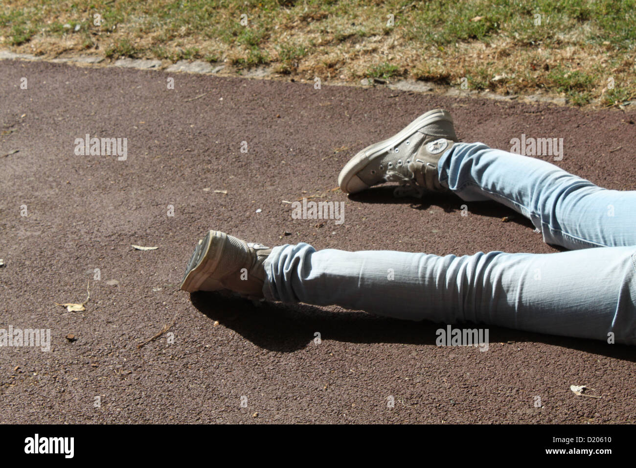 A girl collapsed on the ground Stock Photo - Alamy