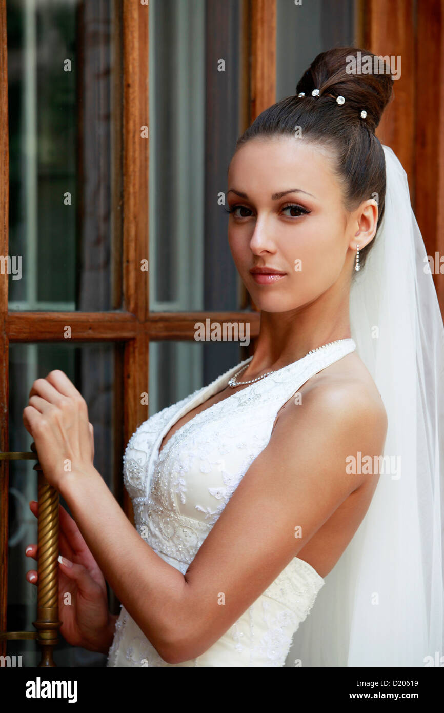 The beautiful bride about a door. Natural illumination Stock Photo - Alamy