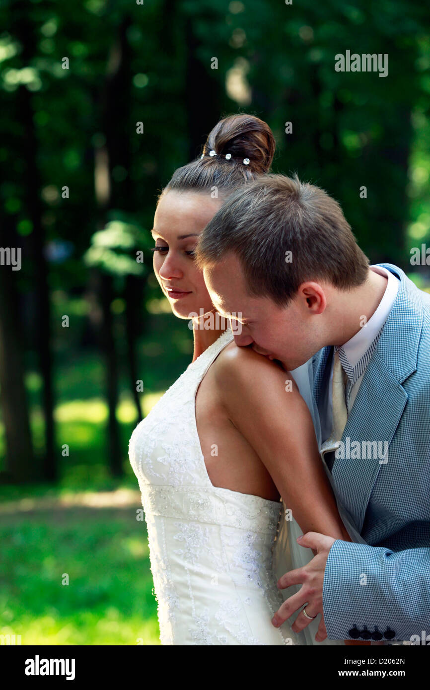 Beautiful the bride and the groom in summer park Stock Photo - Alamy