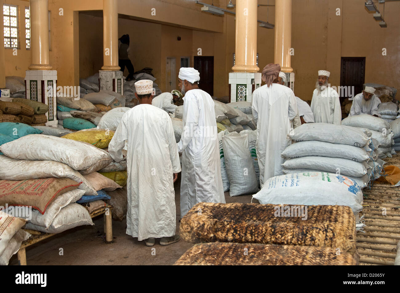 Arab merchants of dates bargaining at the date market, Nizwa, Sultanate ...
