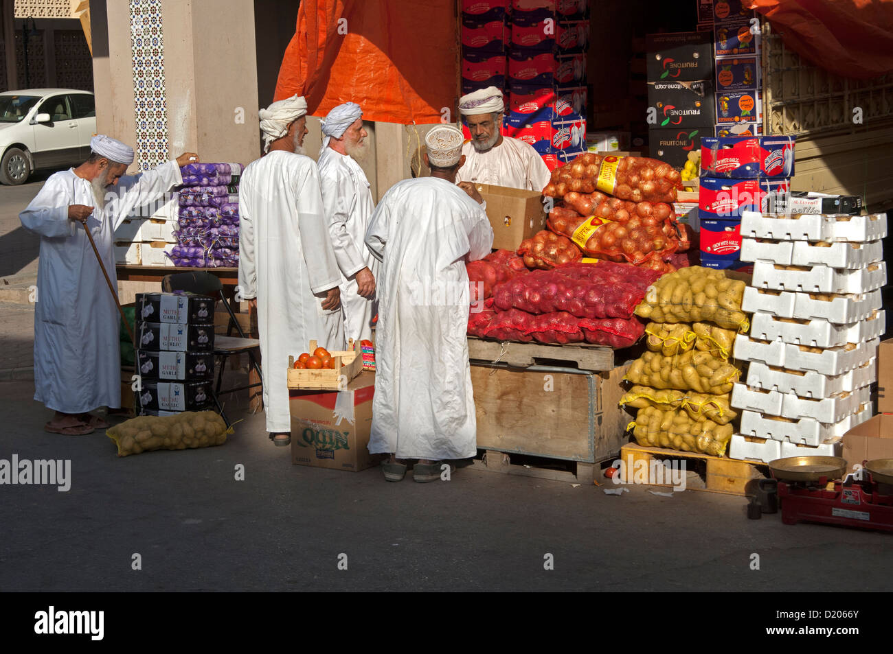 Omani men do shopping at a market stall, Nizwa, Sultanate of Oman Stock ...
