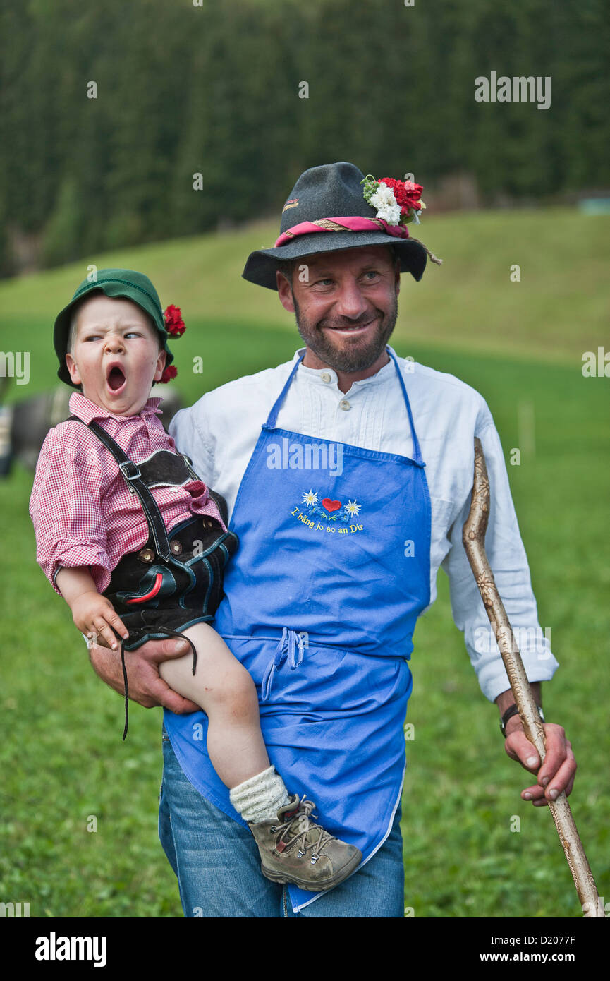 Farmer and son wearing traditional clothes, drive fromthe mountain ...