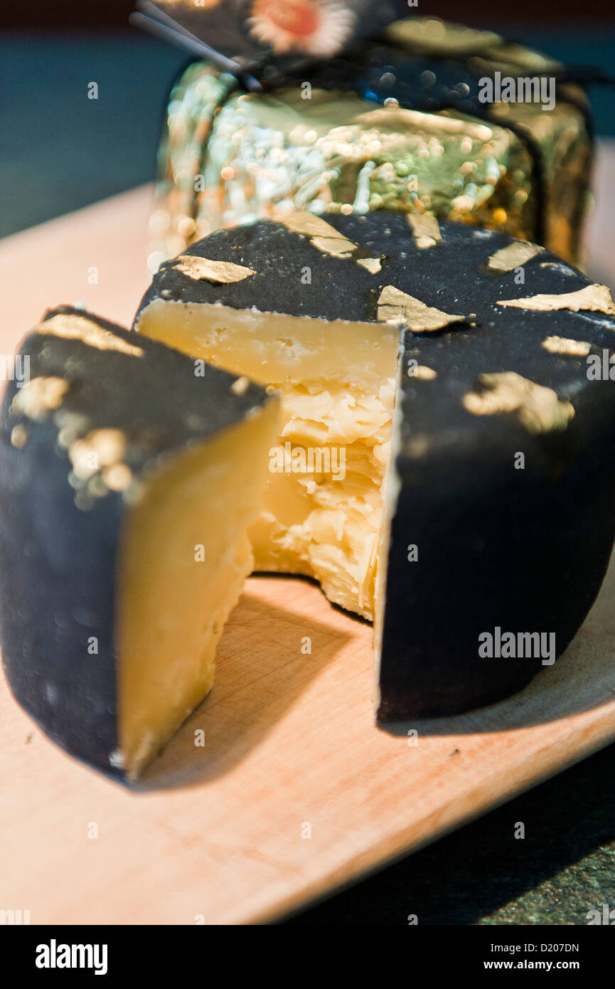 Chunk of cheese with gold leaf, De gust, South Tyrol, Italy Stock Photo ...