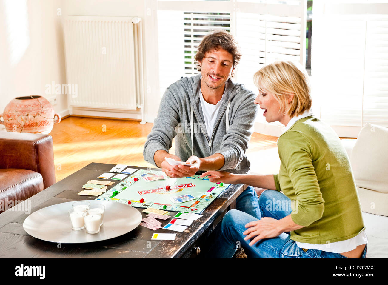 Young couple playing monopoly, Hamburg, Germany Stock Photo - Alamy