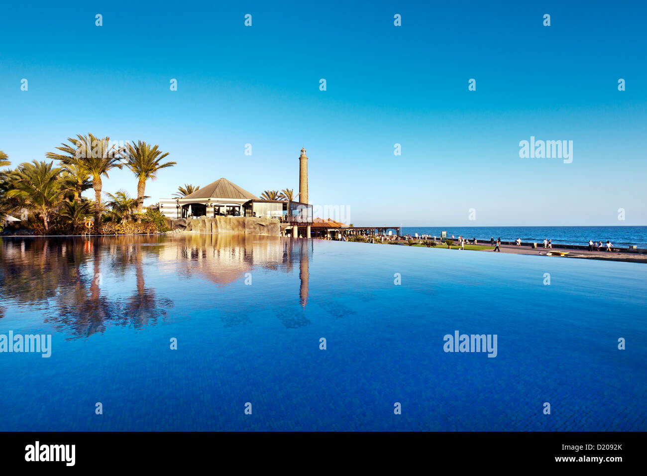 Pool of the Grand Hotel Costa and lighthouse under blue sky, Meloneras ...